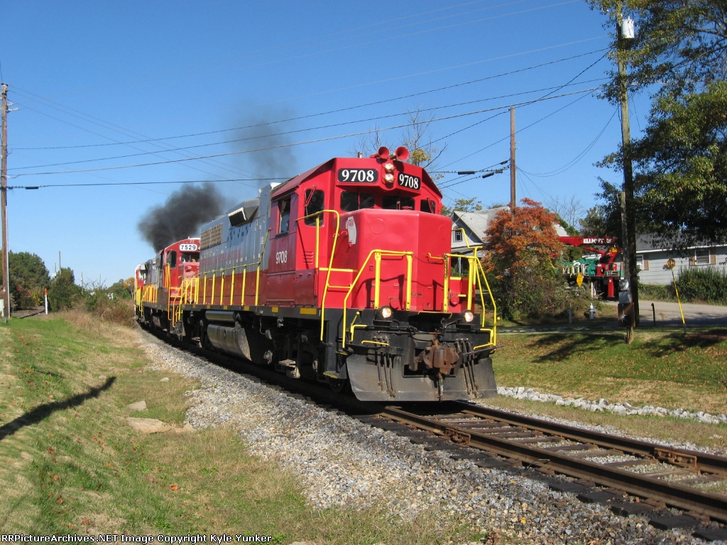 GNRR 9708 leads a freight through the small town of Holly Springs